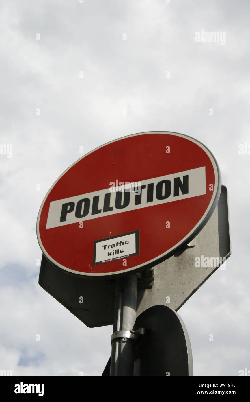 pollution sticker placed on no entry road traffic sign in city town ...