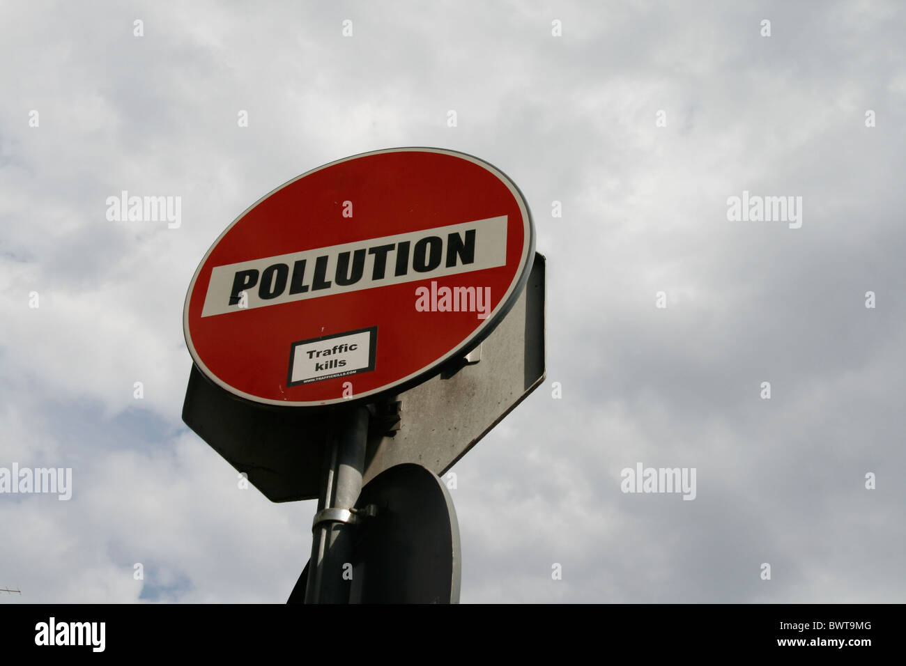 pollution sticker placed on no entry road traffic sign in city town ...