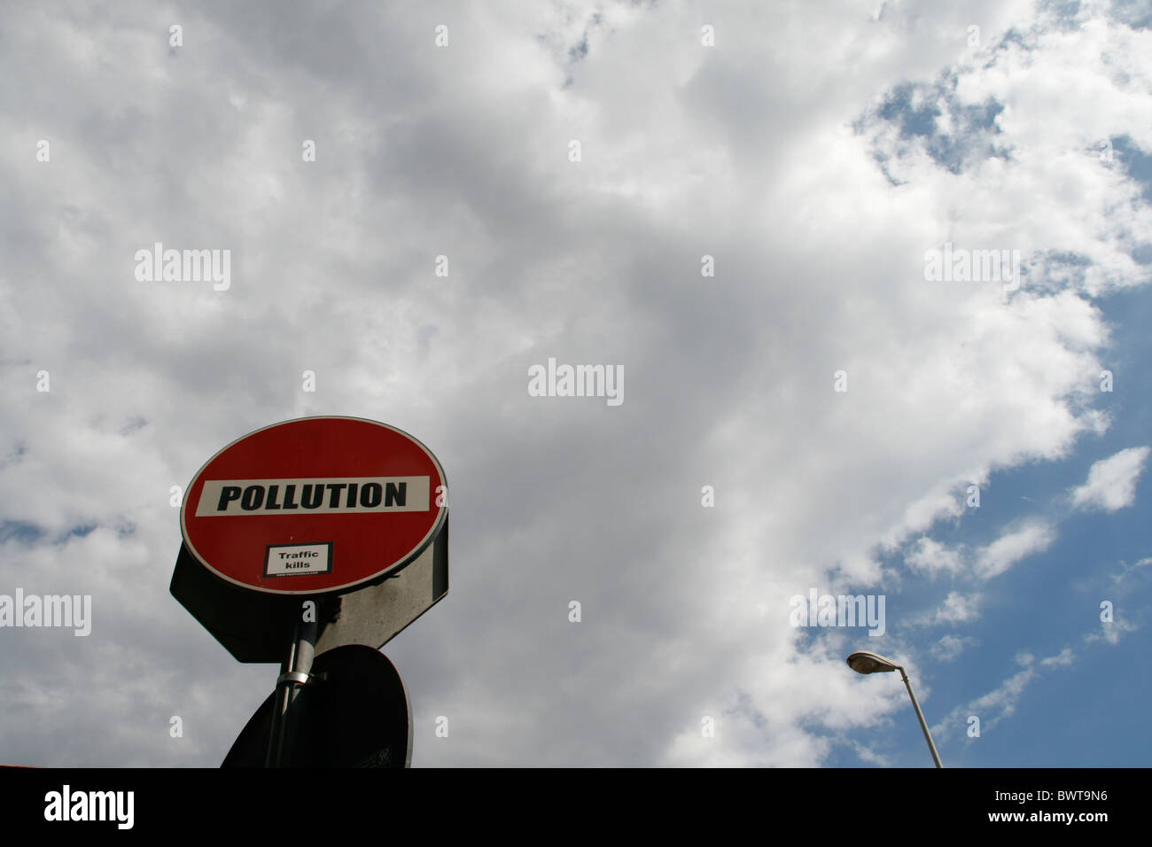pollution sticker placed on no entry road traffic sign in city town ...