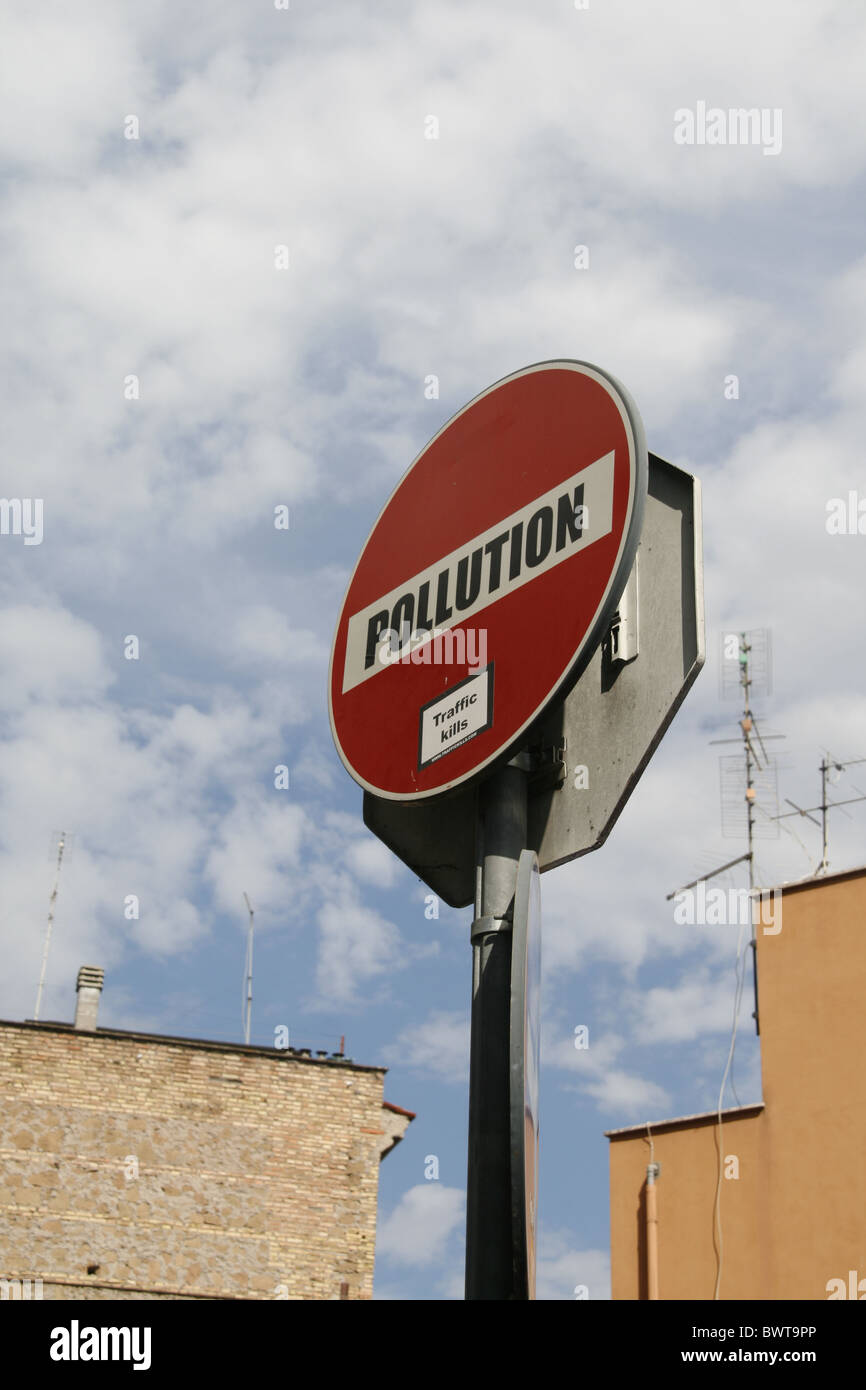 pollution sticker placed on no entry road traffic sign in city town ...