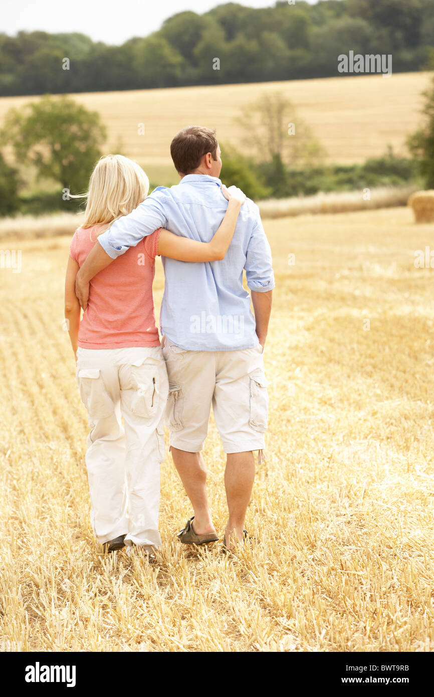 Couple Walking Together Through Summer Harvested Field Stock Photo - Alamy