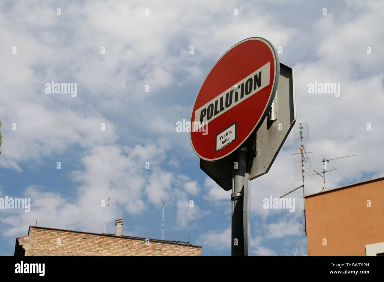 pollution sticker placed on no entry road traffic sign in city town ...