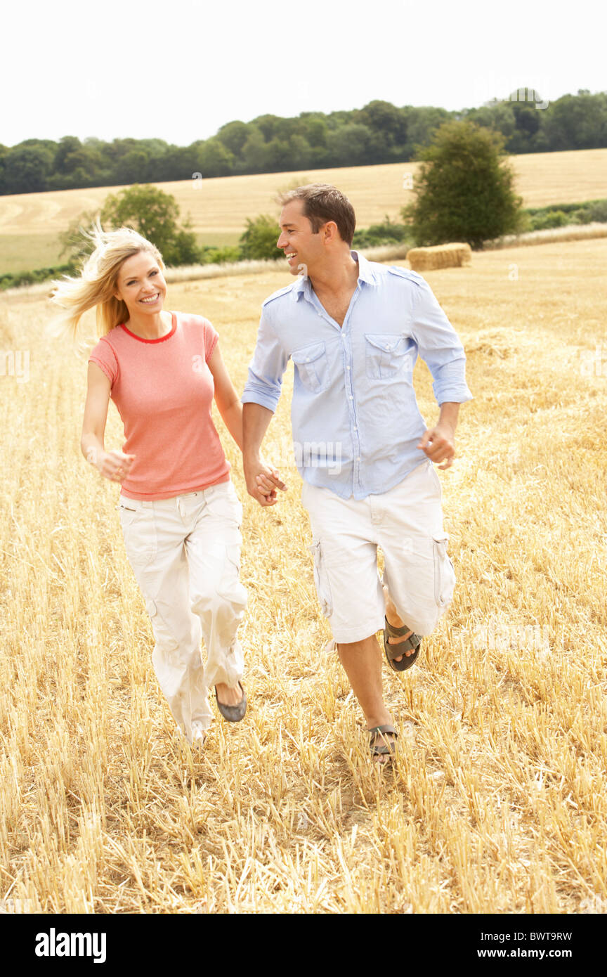 Couple Running Together Through Summer Harvested Field Stock Photo - Alamy