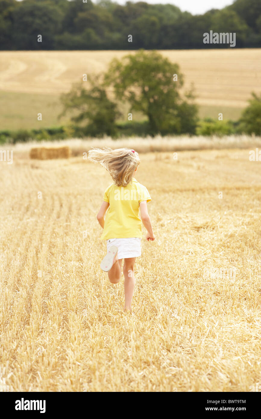 Girl Running Through Summer Harvested Field Stock Photo - Alamy