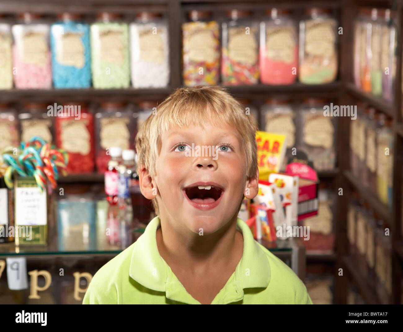 Excited Boy Standing In Sweet Shop Stock Photo - Alamy