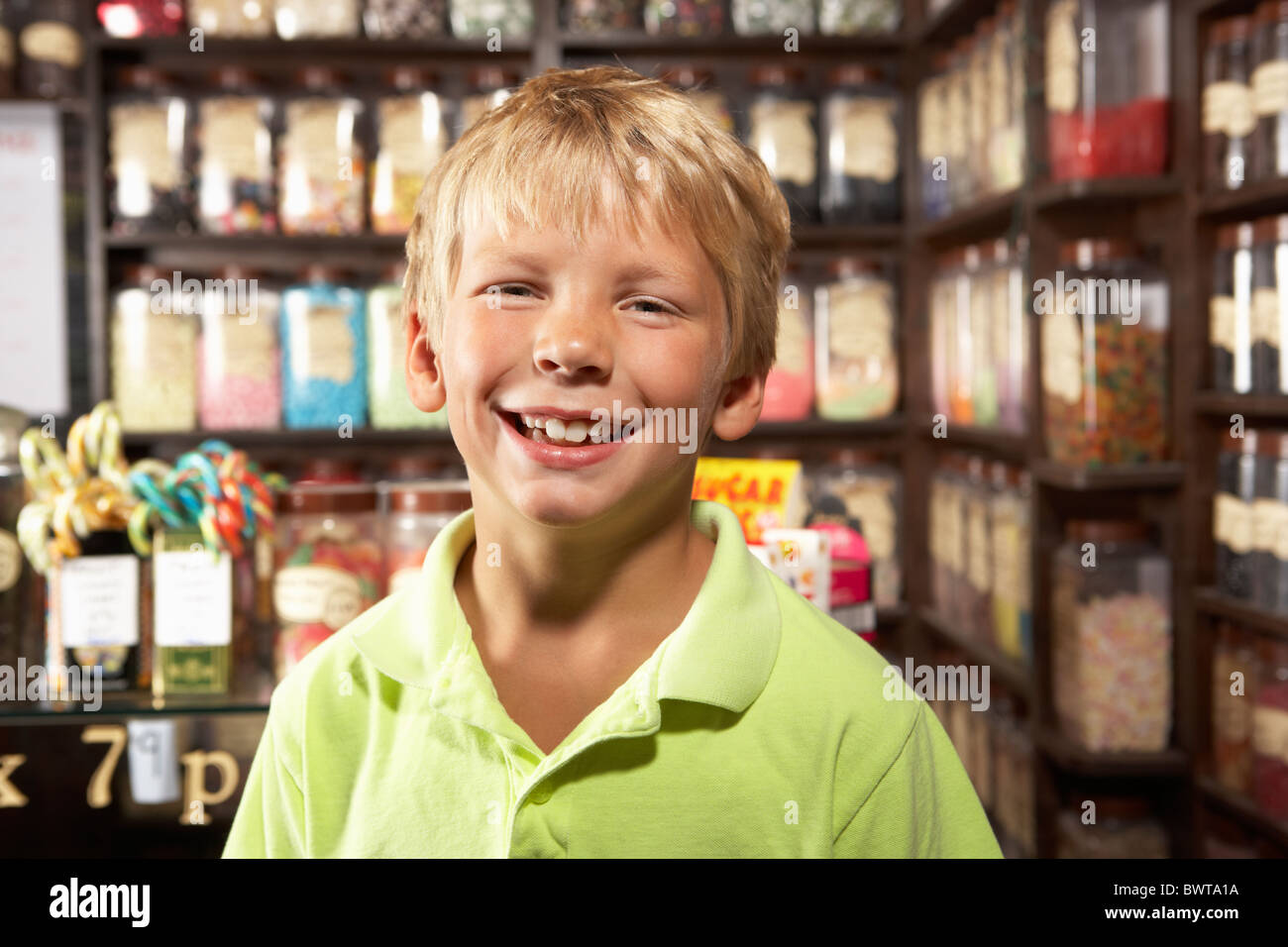 Excited Boy Standing In Sweet Shop Stock Photo - Alamy