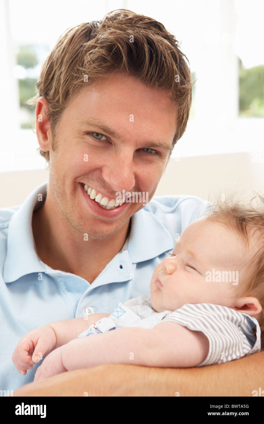 Close Up Of Father Cuddling Newborn Baby Boy At Home Stock Photo - Alamy