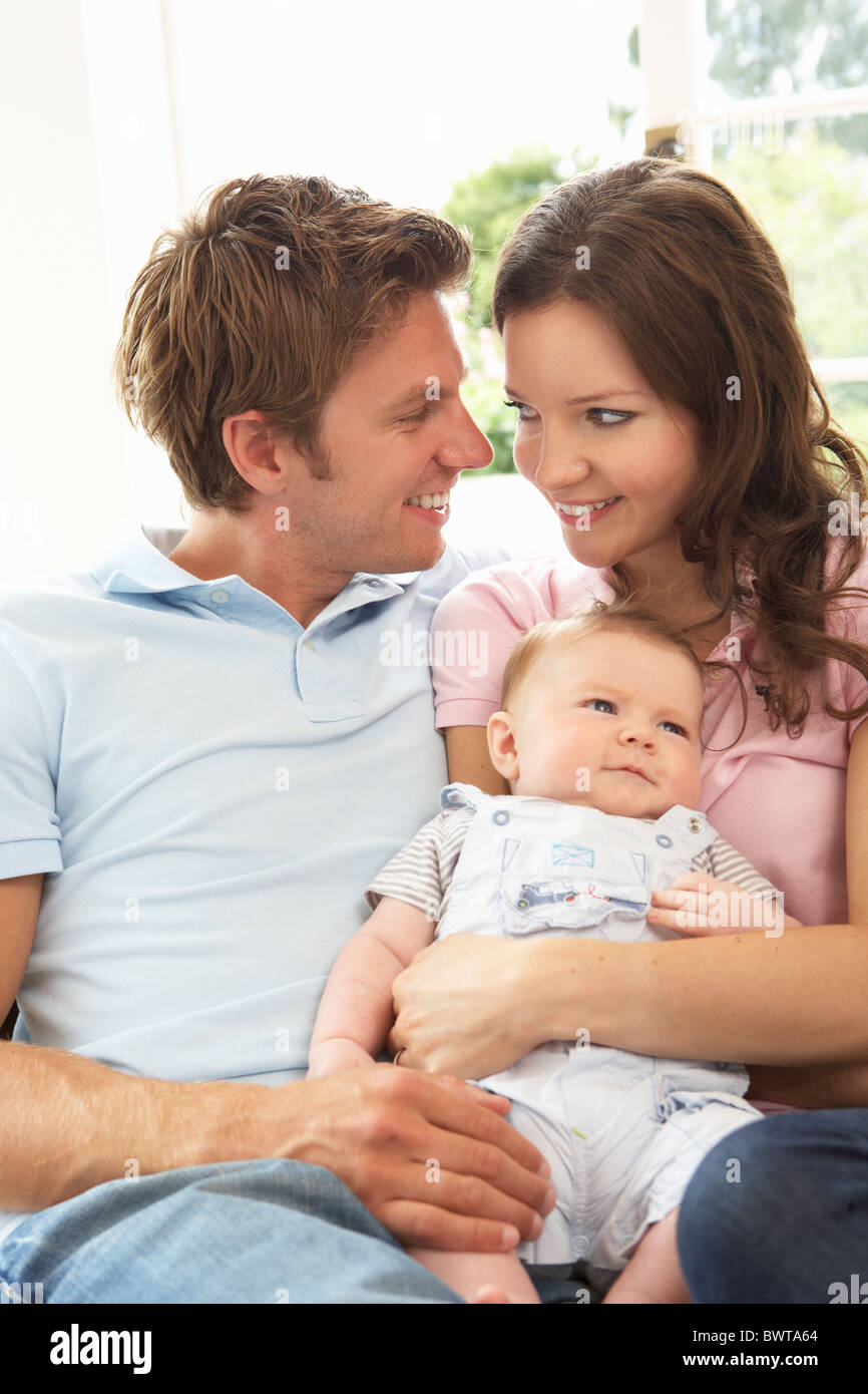 Parents Cuddling Newborn Baby Boy At Home Stock Photo - Alamy