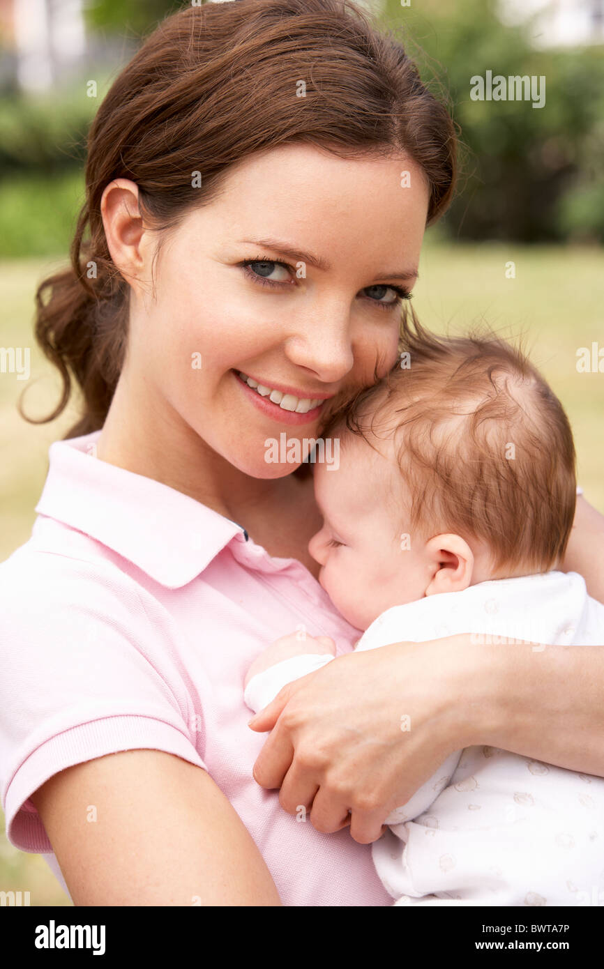 Close Up Of Mother Cuddling Newborn Baby Boy Outdoors At Home Stock ...