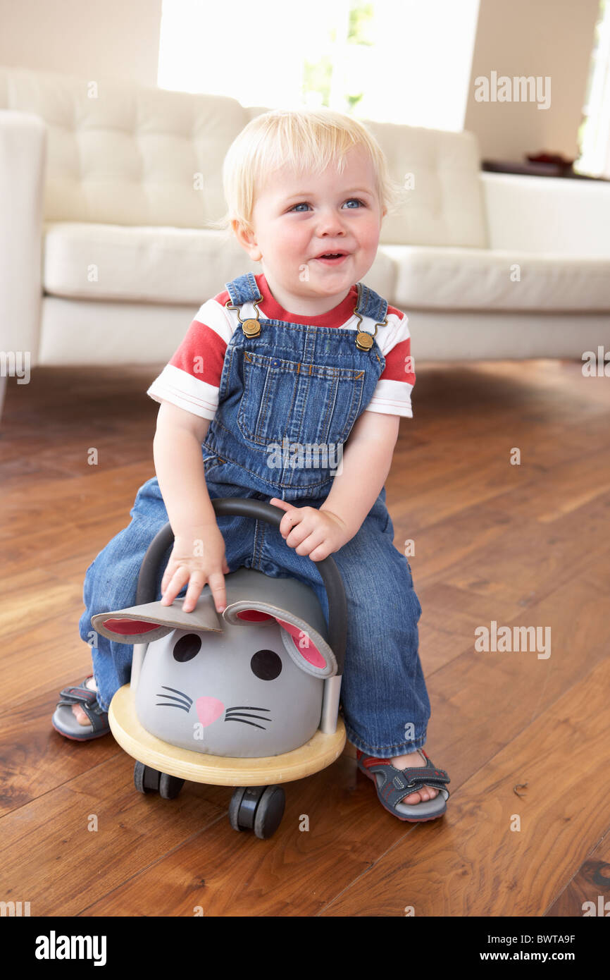 Young Boy Playing With Ride On Toy Mouse At Home Stock Photo - Alamy