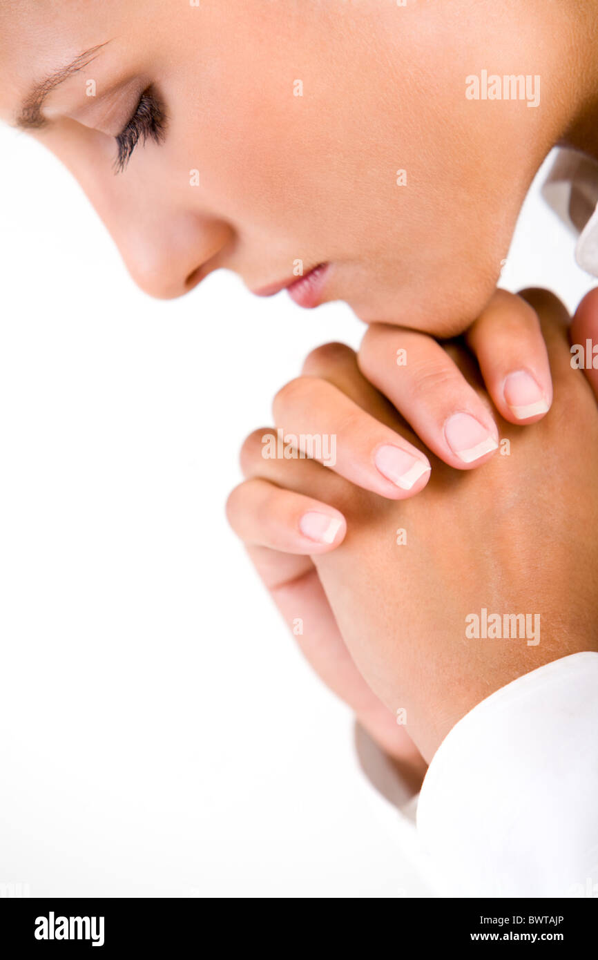 Profile of thoughtful female with her hands by face over white ...