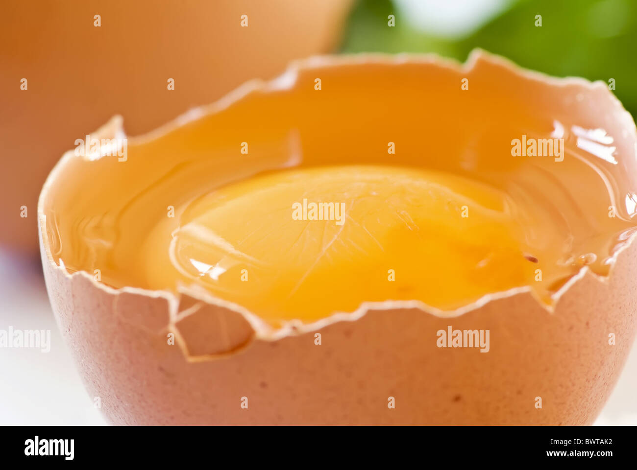 Raw broken egg as closeup on white background Stock Photo - Alamy