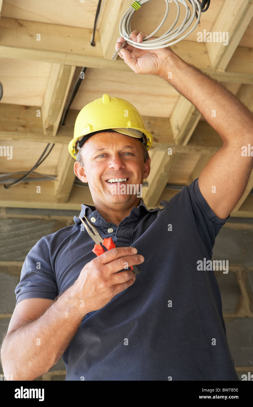 Electrician Working On Wiring In New Home Stock Photo - Alamy