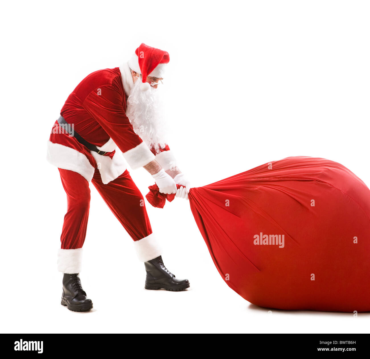 Portrait of happy Santa carrying heavy big red sack with presents Stock ...