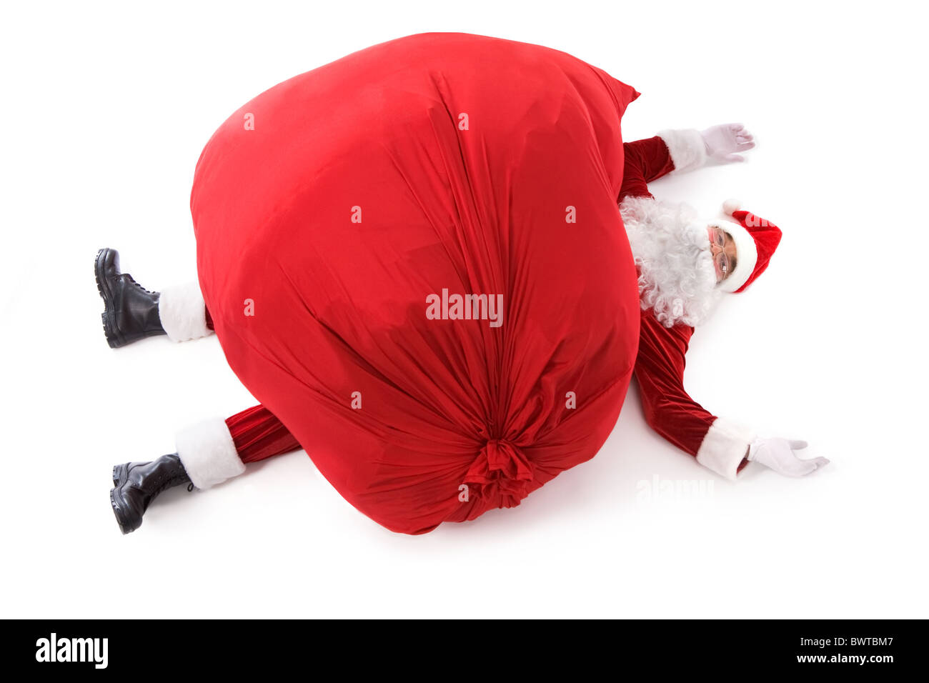 Photo of tired Santa Claus with big red sack on his top Stock Photo - Alamy