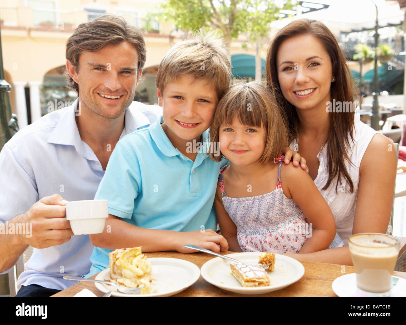 Family Enjoying Cup, Coffee Cake Café Together Stock Photo - Alamy