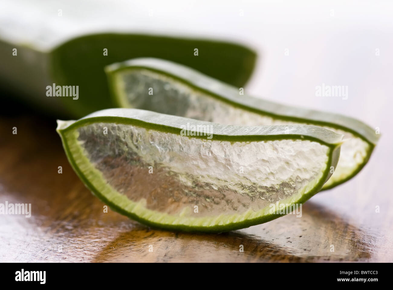 Aloe leaves with cut aloe slice as closeup on white background Stock ...
