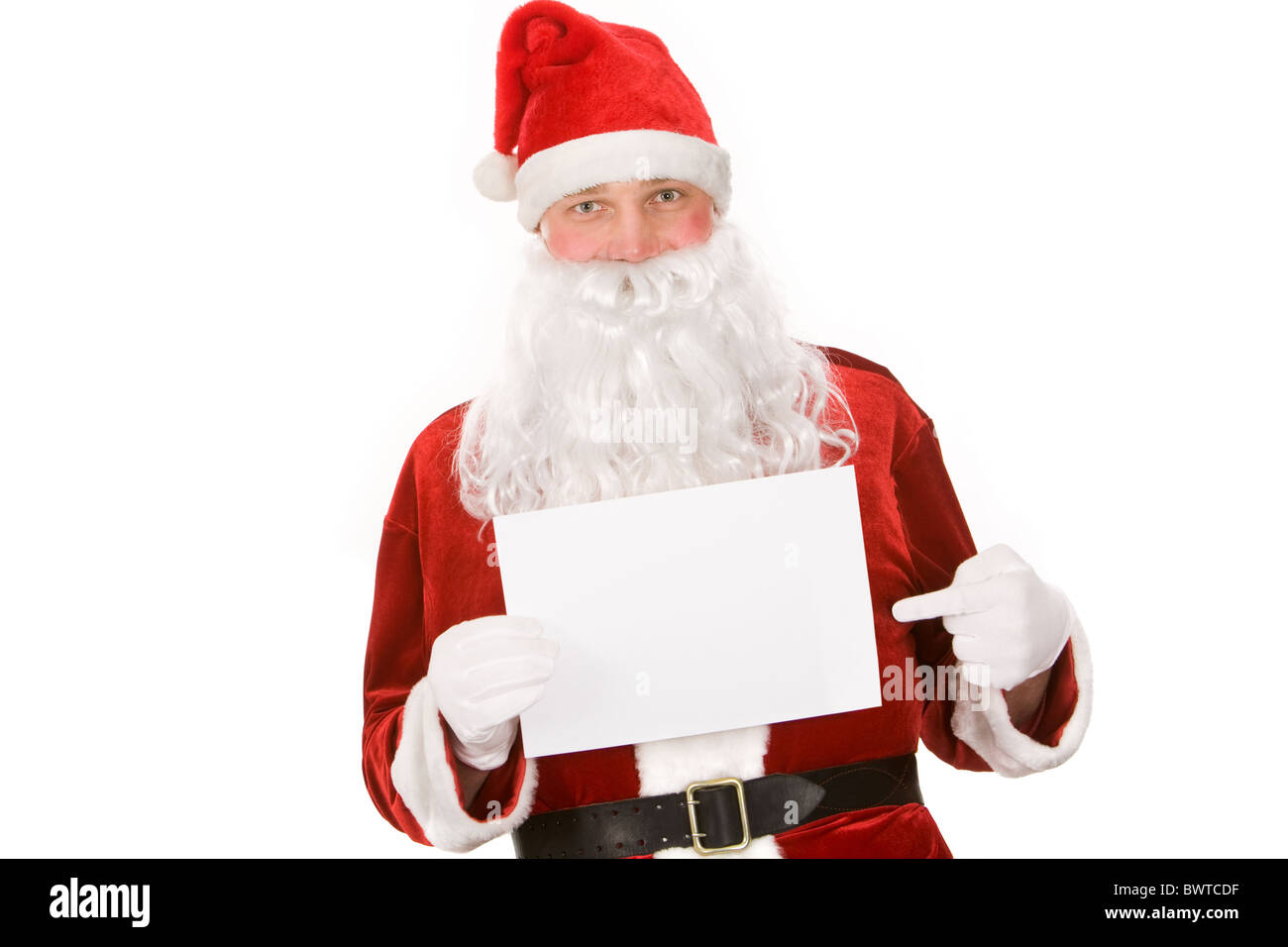 Photo of happy Santa Claus looking at camera while pointing at paper in ...