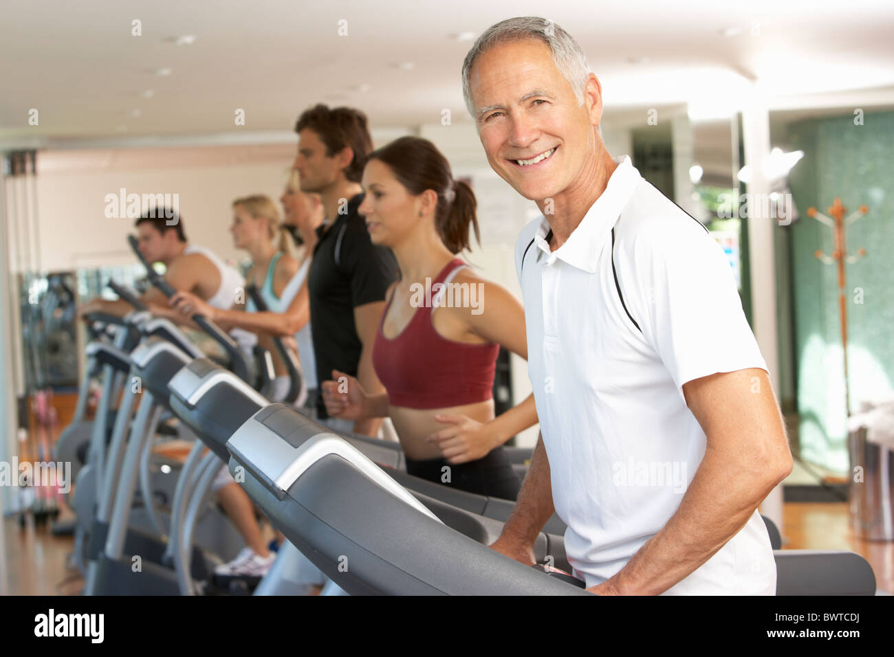 Senior Man On Running Machine In Gym Stock Photo - Alamy