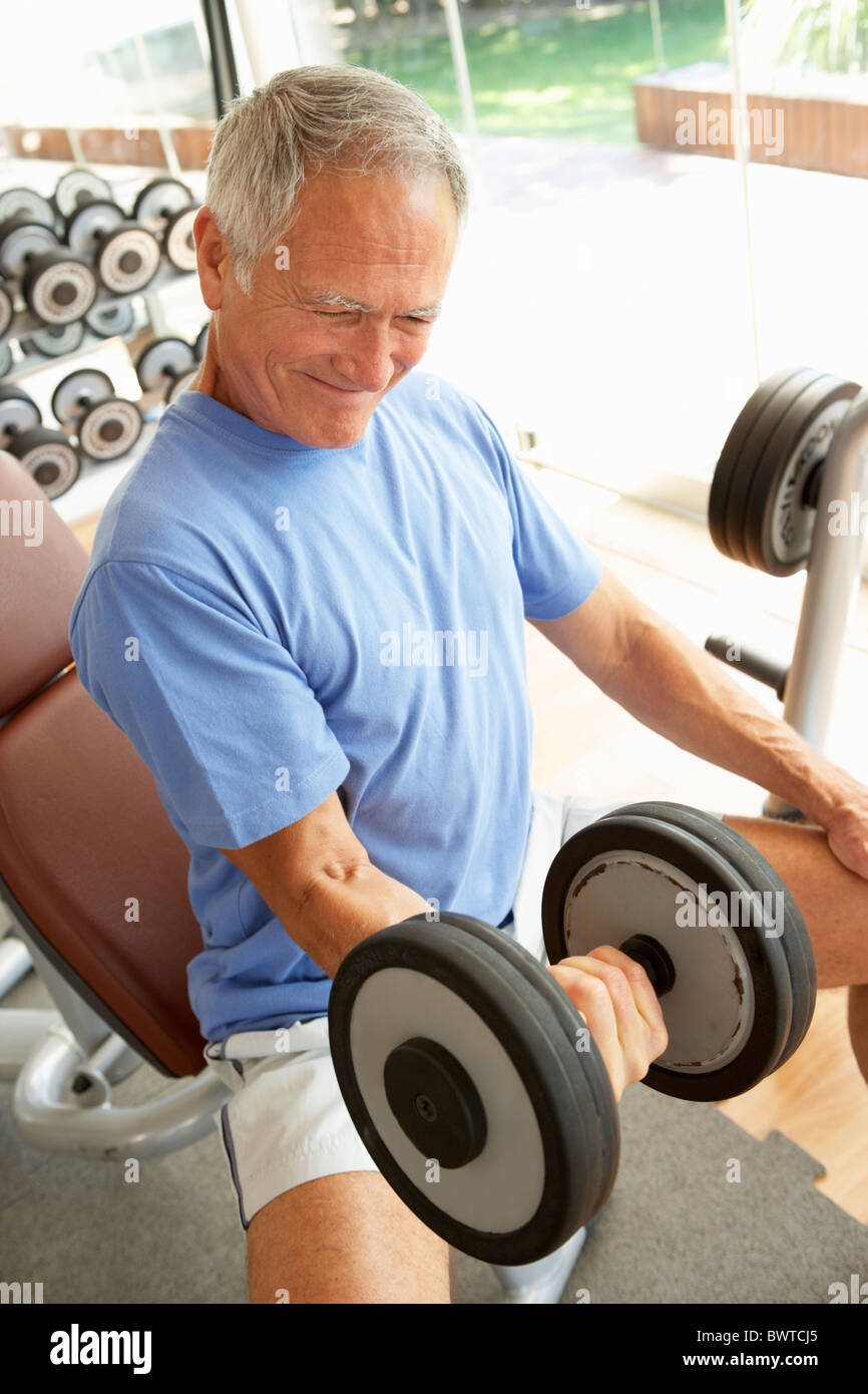 Senior Man Working With Weights In Gym Stock Photo - Alamy