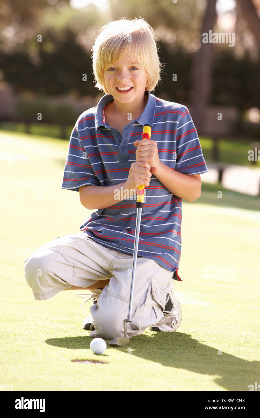 Young Boy Practising Golf On Putting On Green Stock Photo - Alamy
