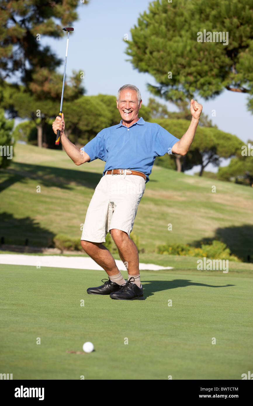 Senior Male Golfer On Golf Course Putting On Green Stock Photo - Alamy