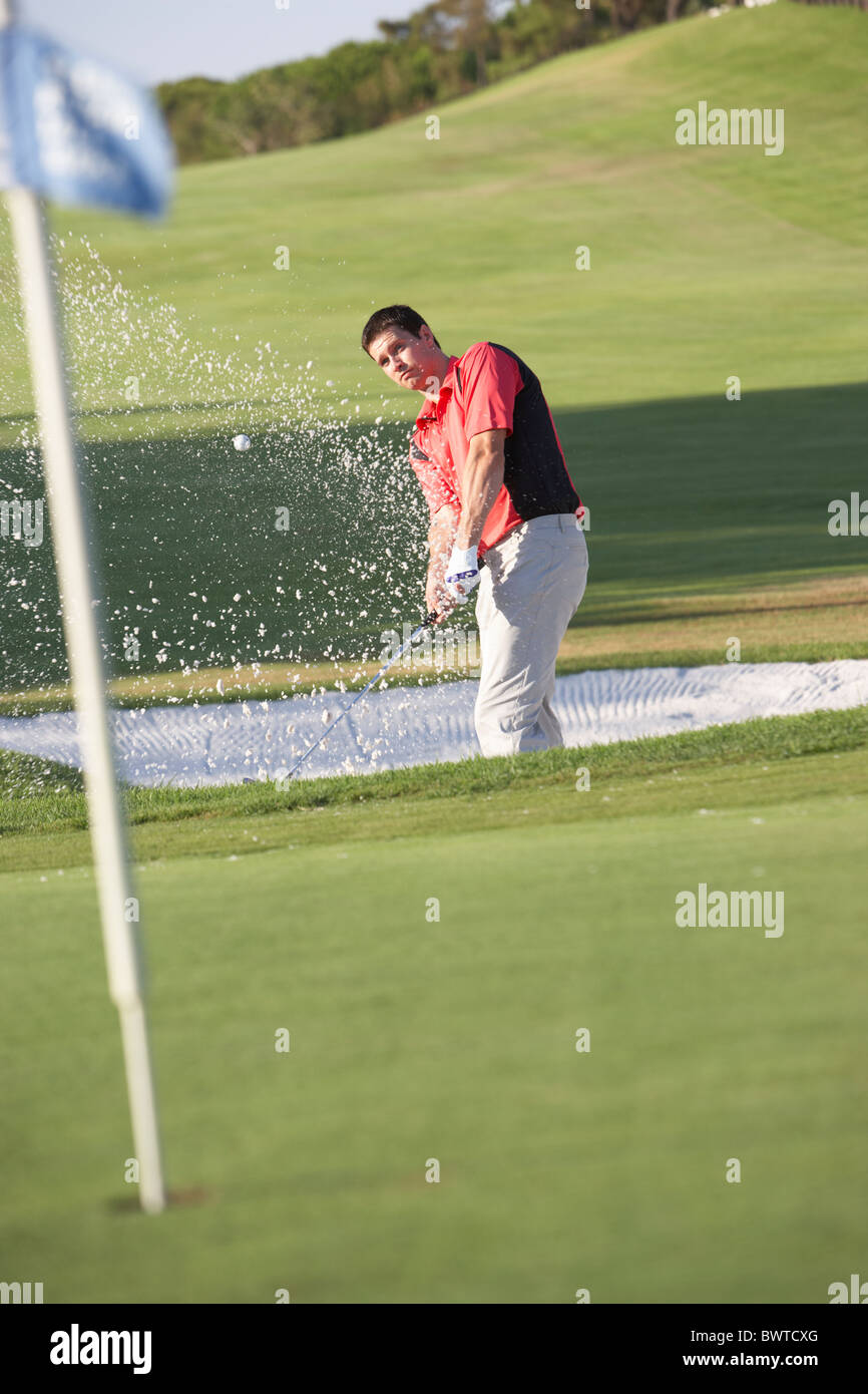 Male Golfer Playing Bunker Shot On Golf Course Stock Photo - Alamy