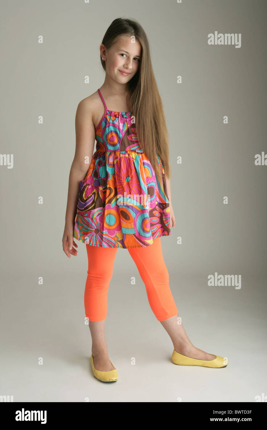 Portrait of a ten year old girl standing in a studio Stock Photo - Alamy