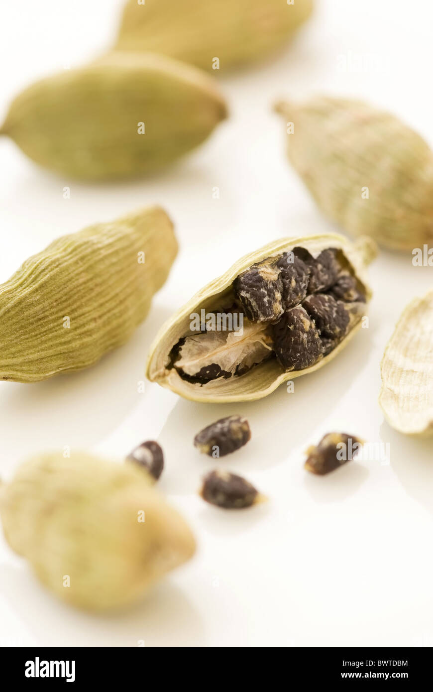 Green cardamom seed as closeup on white background Stock Photo - Alamy