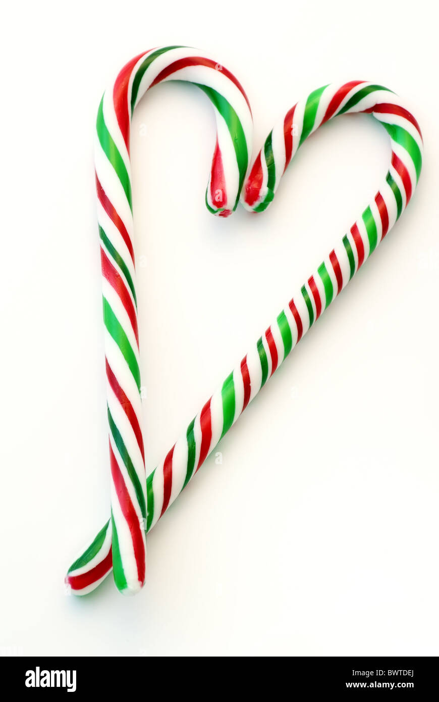 Colored candy cane as closeup on white background Stock Photo - Alamy
