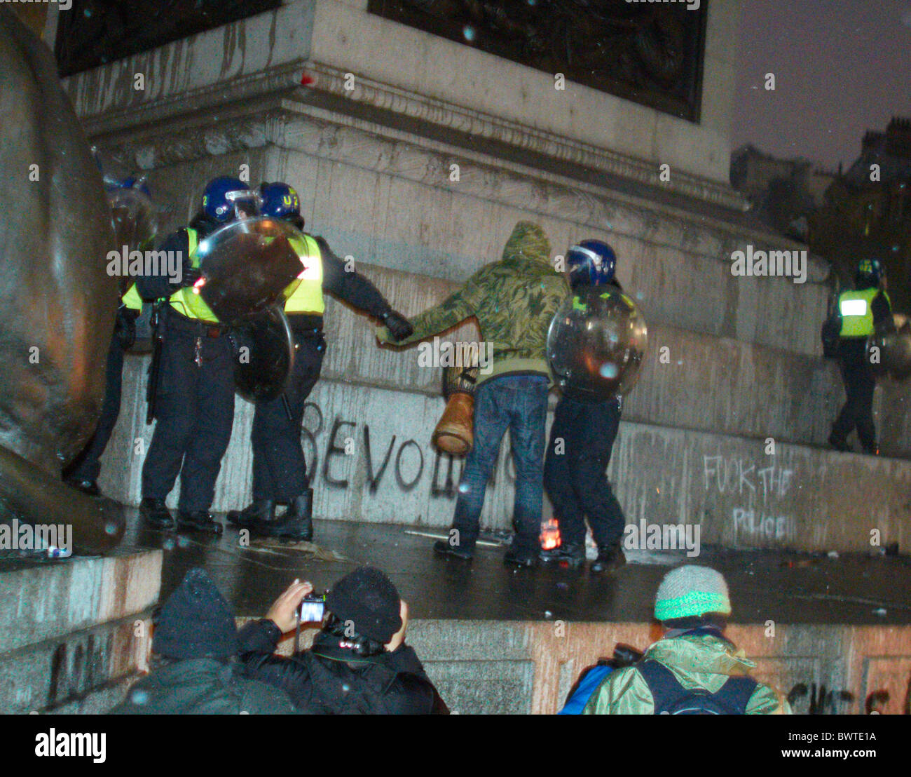 Riot police arrest a demonstrator on Nelson's Column during student ...
