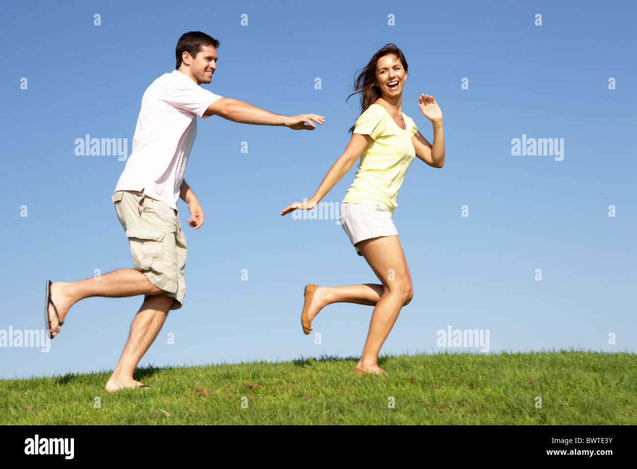 Young man running through grass hi-res stock photography and images - Alamy