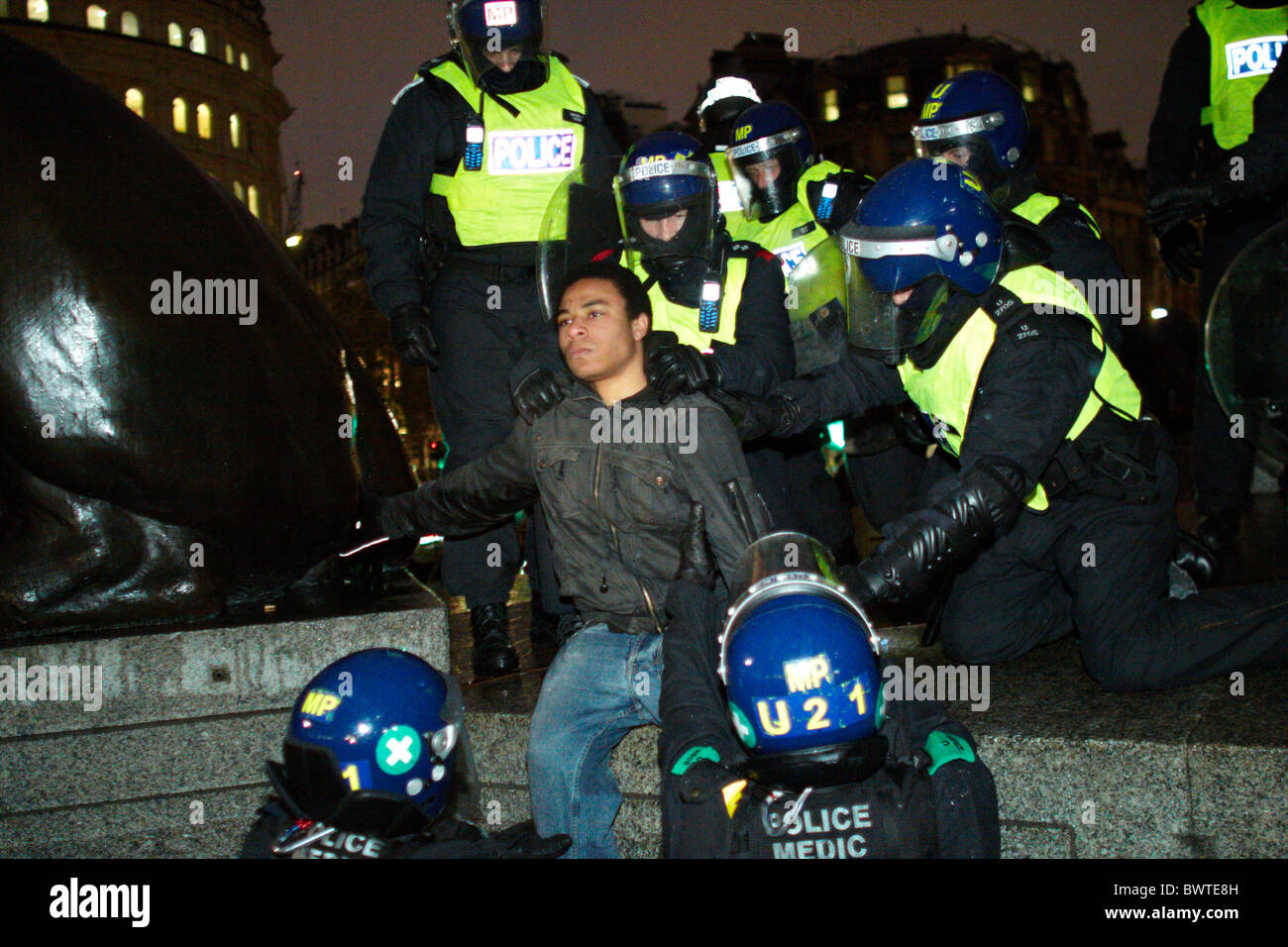 Riot police arrest a demonstrator on Nelson's Column during student ...