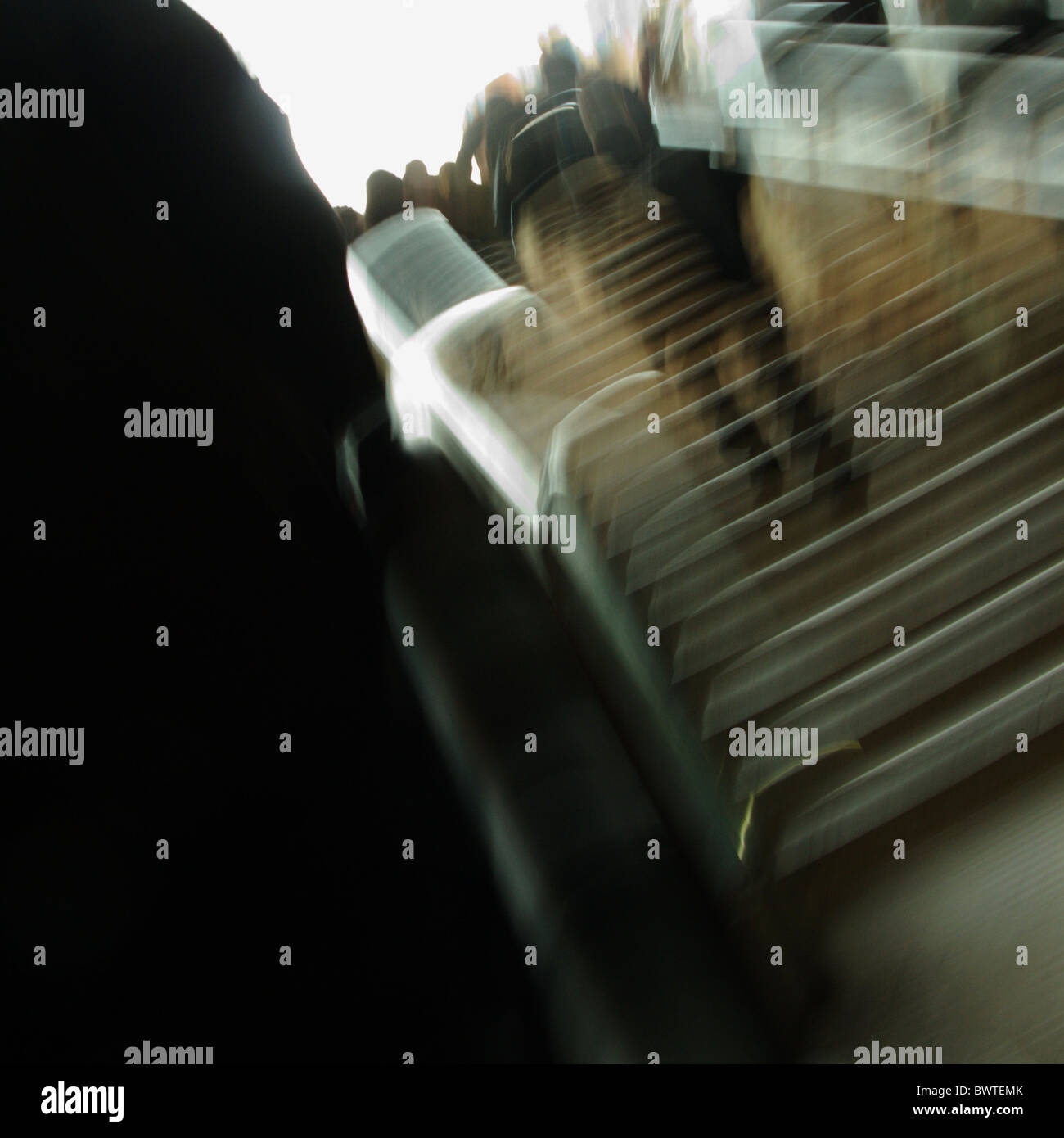 Abstract street scene - travellers on a busy escalator emerging into ...