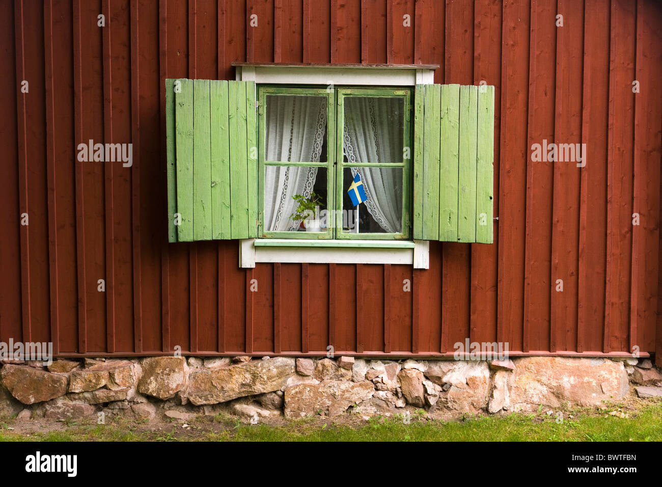 Swedish flag in a window in a small cottage Stock Photo - Alamy