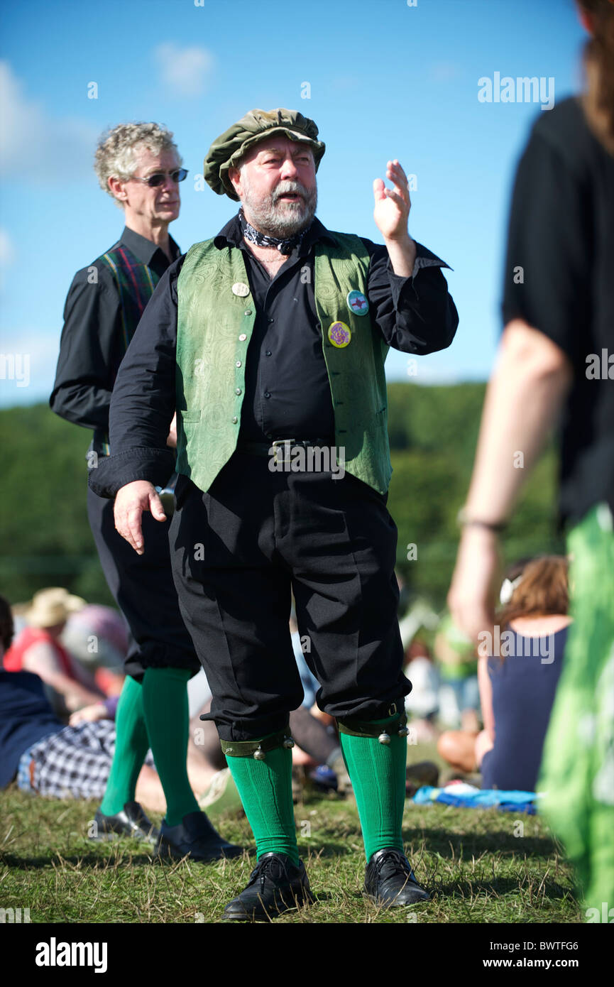 A man announces that an traditional folk dance performance is about to ...