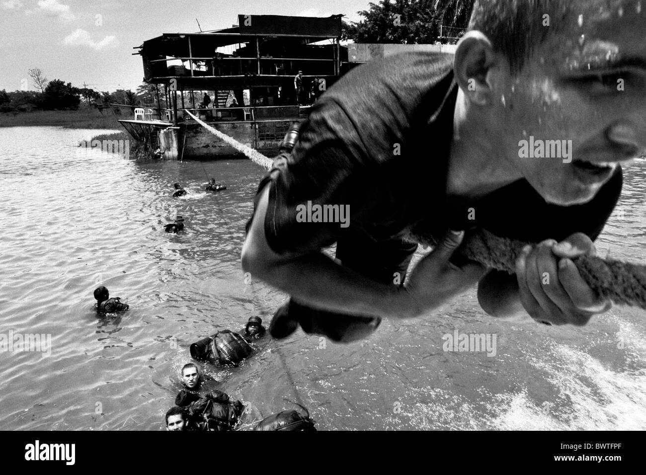 A young Colombian Police recruit climbs a rope during the training for ...