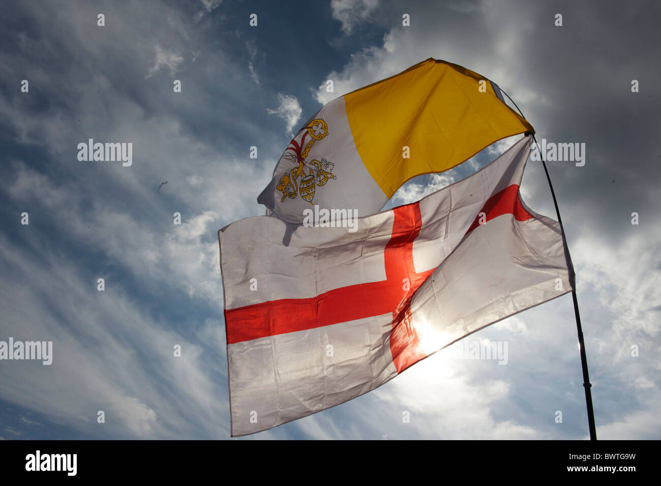 The flag of the papacy and England fly above the estimated 80,000 ...
