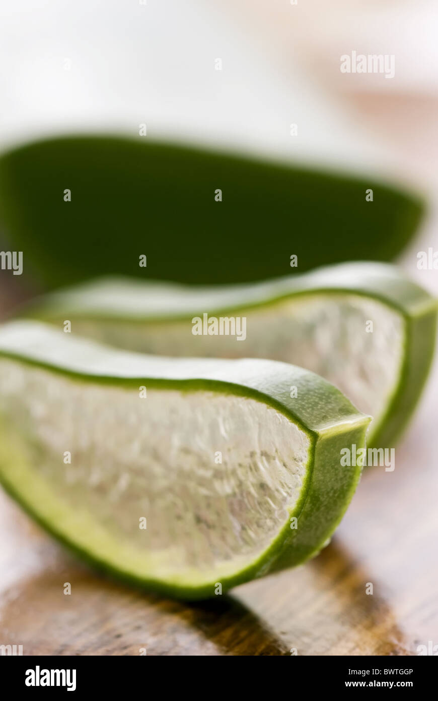 Aloe leaves with cut aloe slice as closeup on white background Stock ...