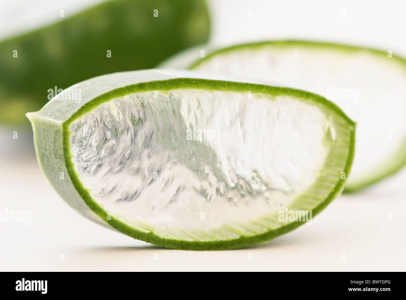 Aloe leaves with cut aloe slice as closeup on white background Stock ...