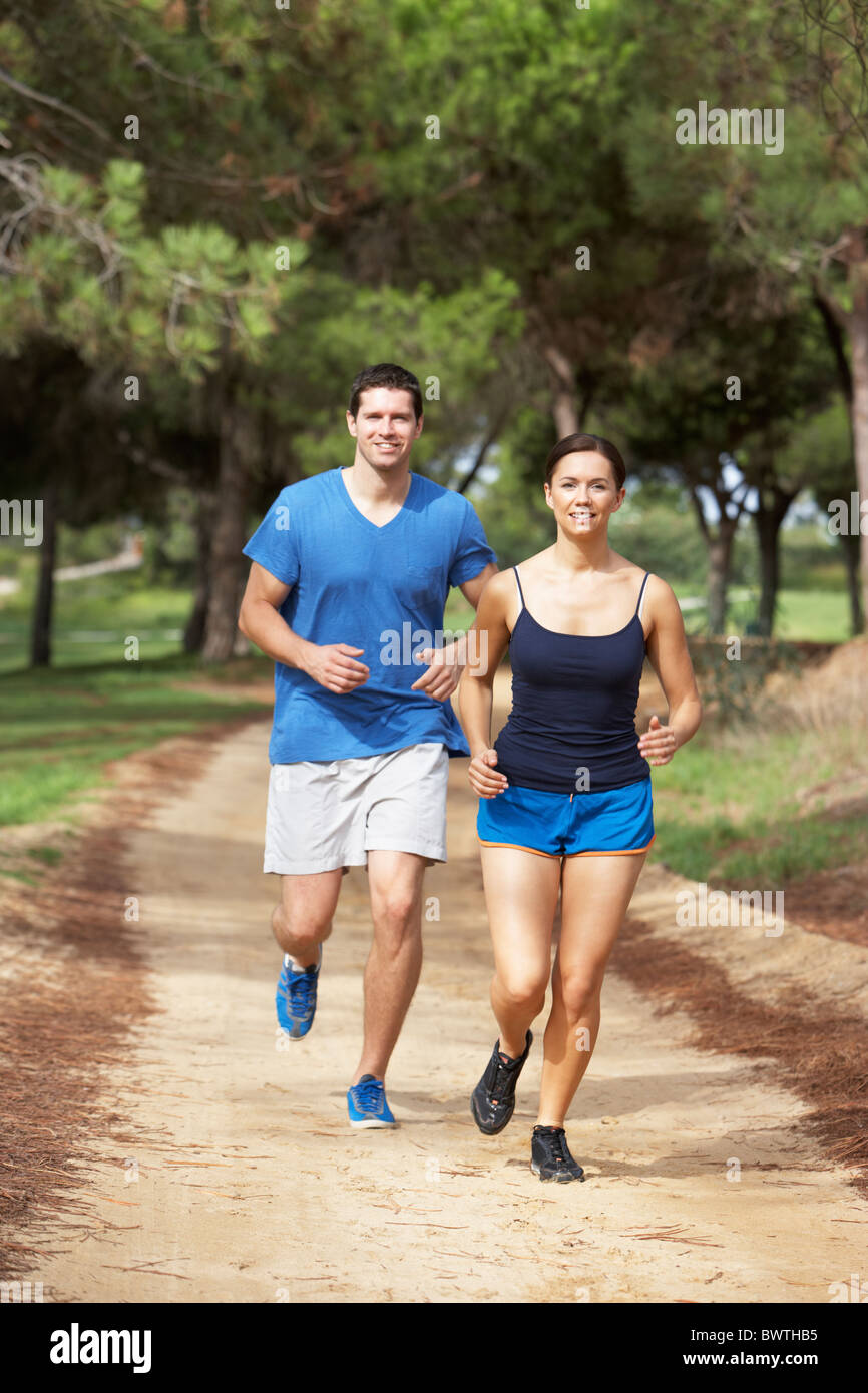 Young man running alone in park Stock Photo - Alamy