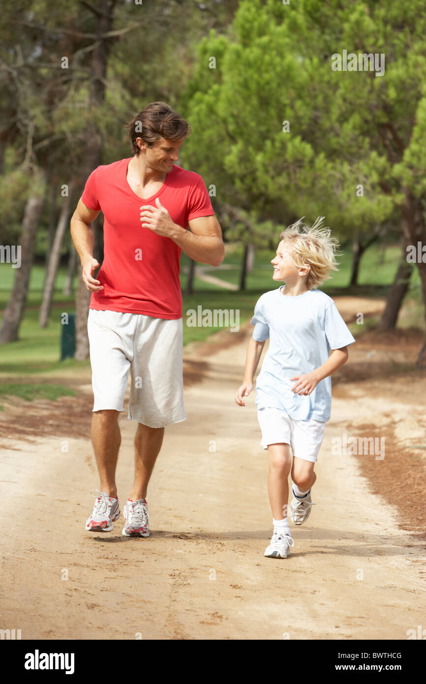 Young man running alone in park Stock Photo - Alamy