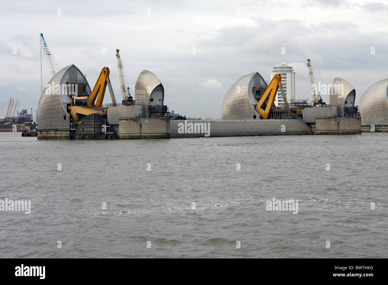Two sections of the Thames Barrier with the barrier raised between them ...