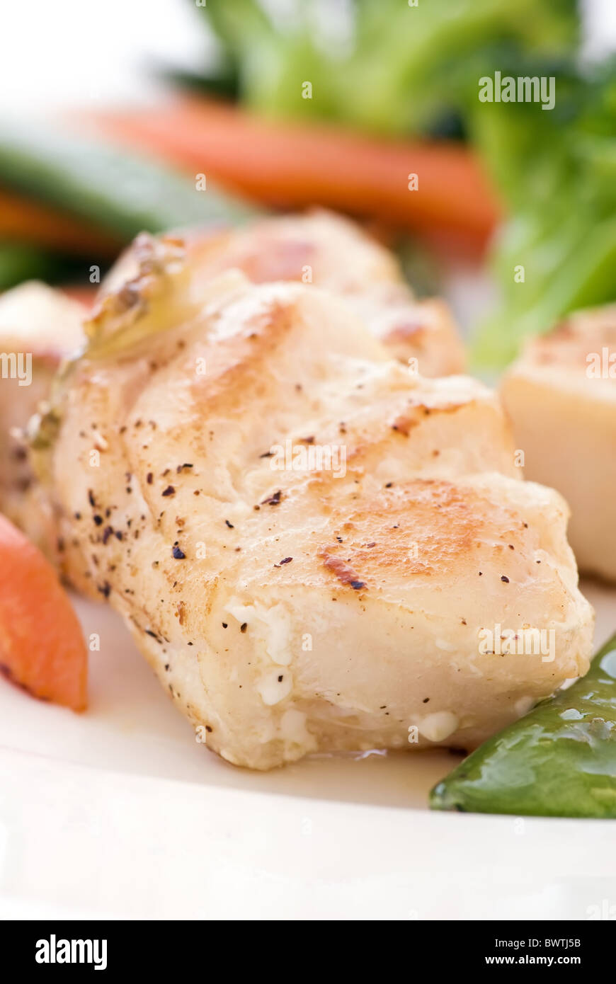 Red snapper filets with vegetable as closeup on a white plate Stock ...