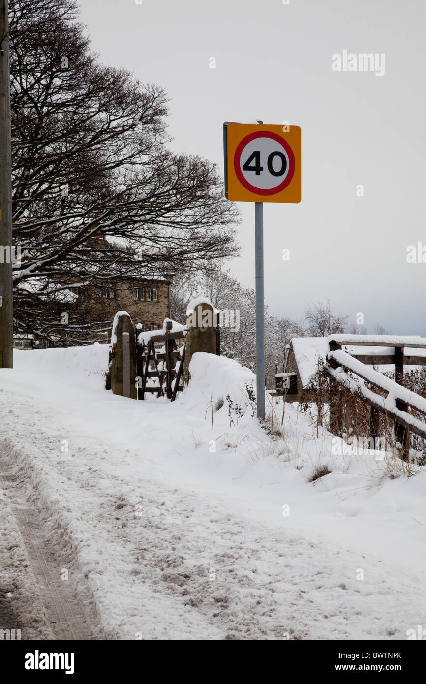 40 mph speed limit road sign in heavy snow conditions during winter in ...