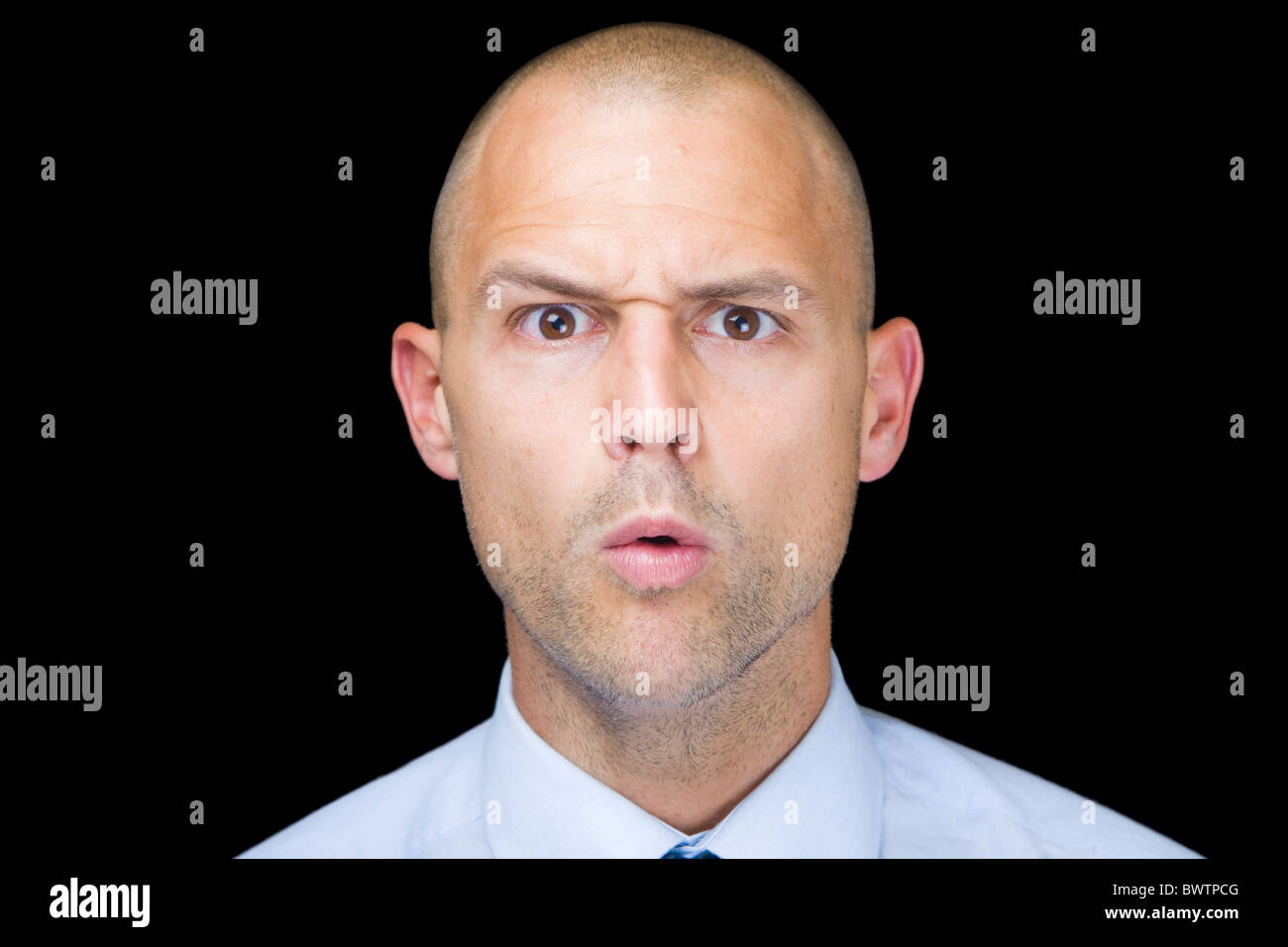 Man isolated over a black background with a humorous, confused look on ...