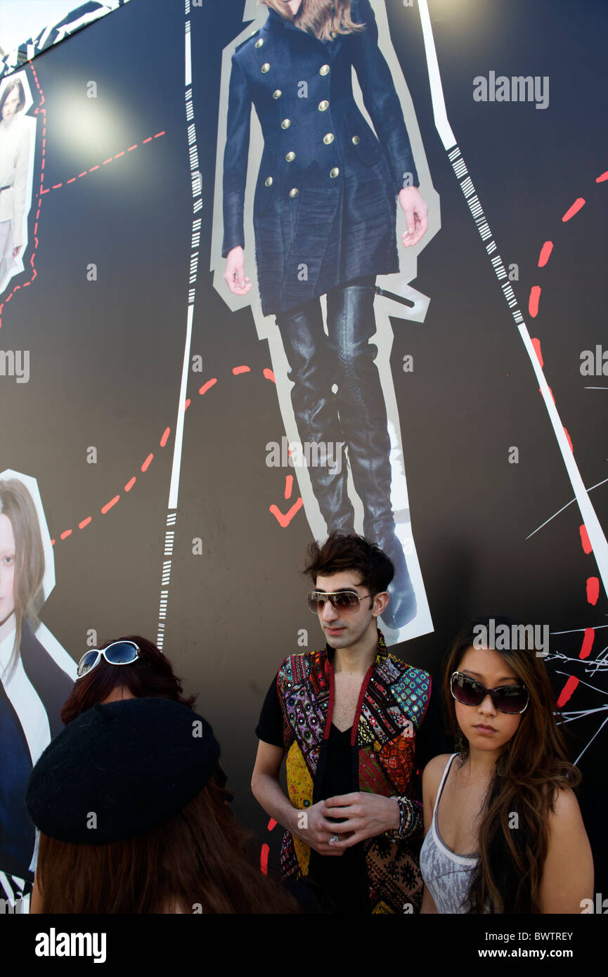 During a pause between catwalk shows, London Fashion Week attendees ...