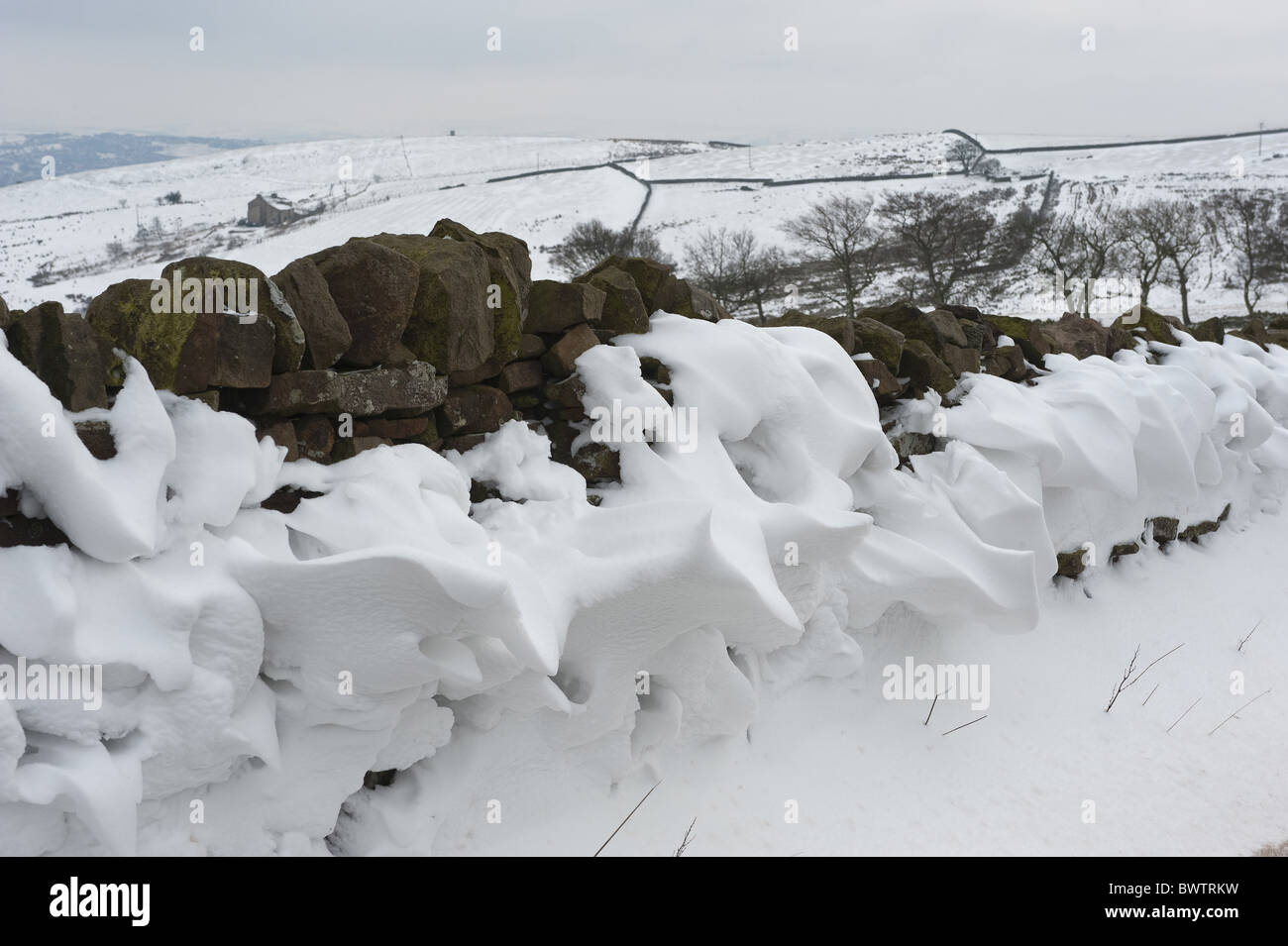 Snowdrift against drystone wall Pendle Lancashire Stock Photo - Alamy
