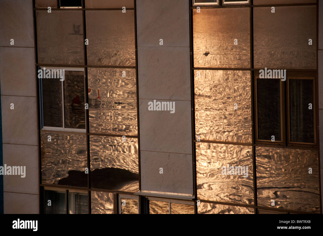 The sunset reflected off a building Stock Photo - Alamy