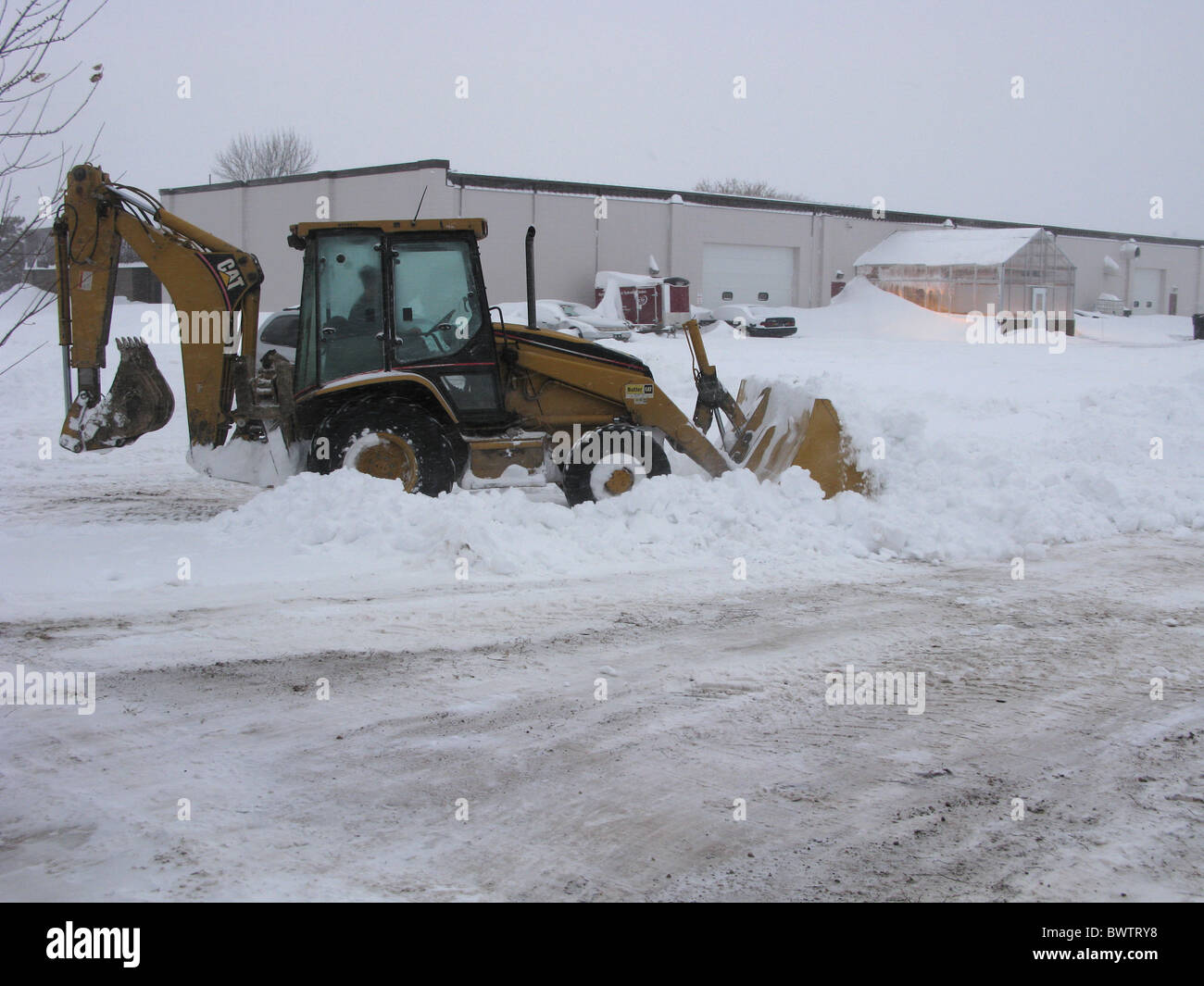 Snow removal after Christmas snowstorm loader Stock Photo - Alamy